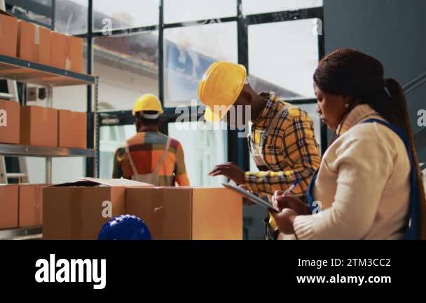Group of warehouse employees preparing containers for stock ...