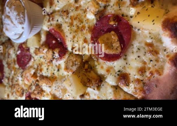 Baked cheesy pizza with smoked sausages and garlic sauce. Vertical food ...