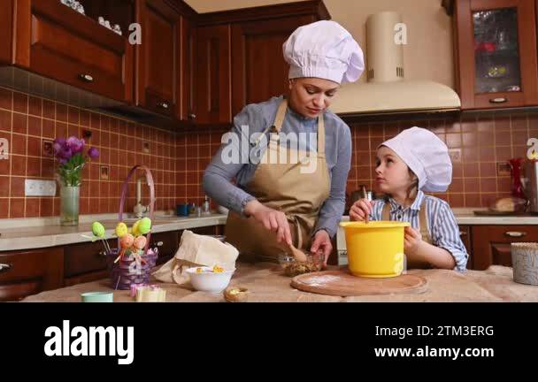 Happy family kneading dough, cooking panettone for Easter holiday. Mom ...