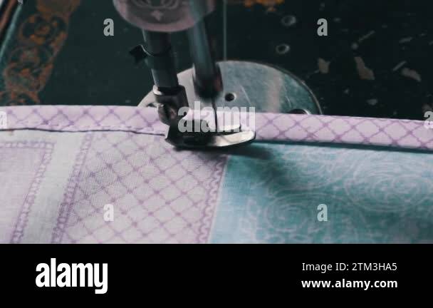 Old female hands of seamstress sew at a retro sewing machine at home in ...