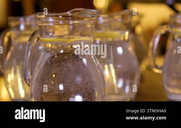 jug with water and lemon serving in a restaurant at a buffet table many ...