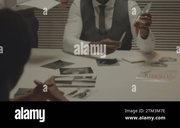 Over the shoulder shot of African American male police officer showing ...
