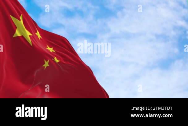 The flag of China waving on a sunny day. Red background, five yellow ...