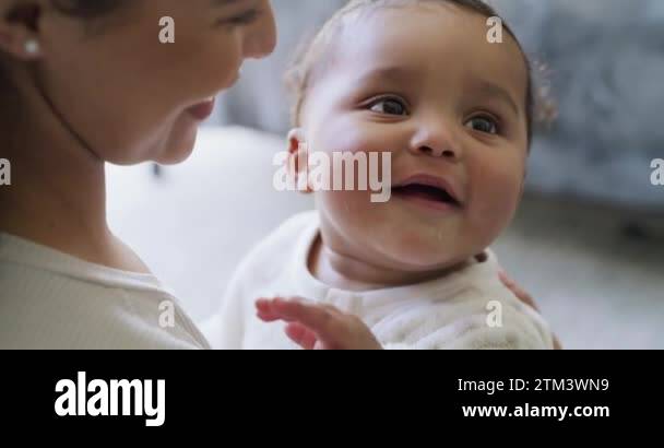 .Baby, closeup and face with mom and smile in a family home feeling ...