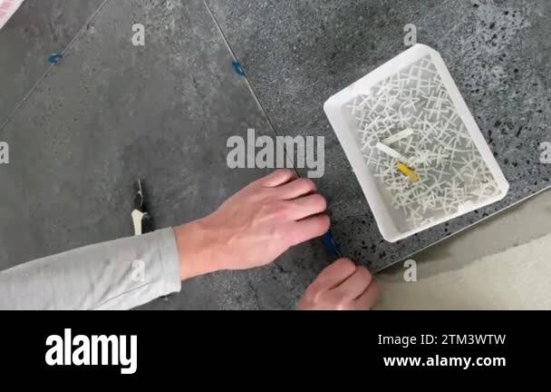4k video footage of laying a large wide-format tile on a mounting ...