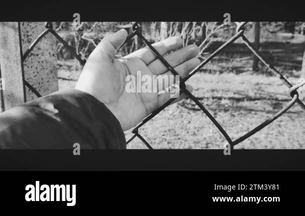 iron grate. steel mesh. the hand is holding the grate. a man's hand ...