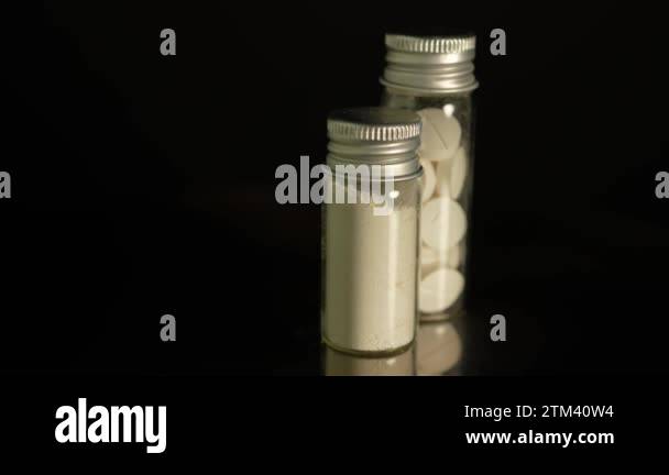 Powdered illegal drugs stored in a glass vial, indicating substance ...