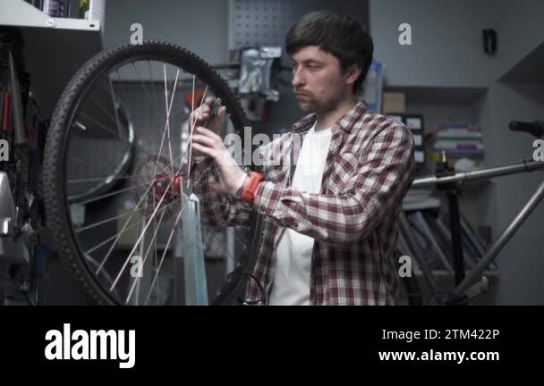 Working alignment of rim and spokes of bicycle wheel on wheel stand in ...