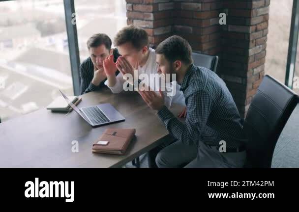 Three men in an office, fascinated and flabbergasted by what theyre ...