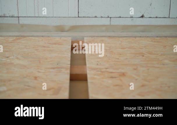 The process of installing a subfloor from oriented strand board in a ...