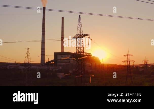 Electricity pylons at sunset. High-voltage electric tower on industrial ...