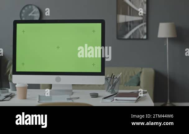 No people shot of computer monitor with green mockup template screen on ...