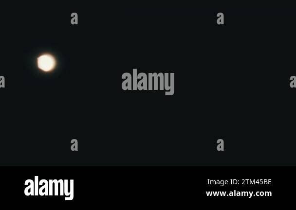 The light of a flashlight into the camera on a black background. Light ...