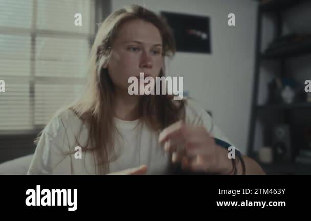 Girl sending text message, throwing phone away and holding head in ...