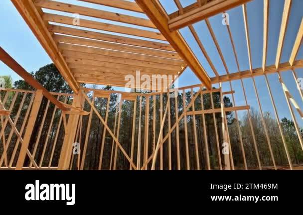Building wooden house begins with framing beams which support layout of ...