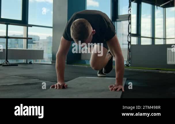 Healthy Caucasian sportsman in sportswear do crossover running plank on ...