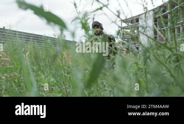 female army sniper walking and aiming in grass carrying her rifle.slow ...