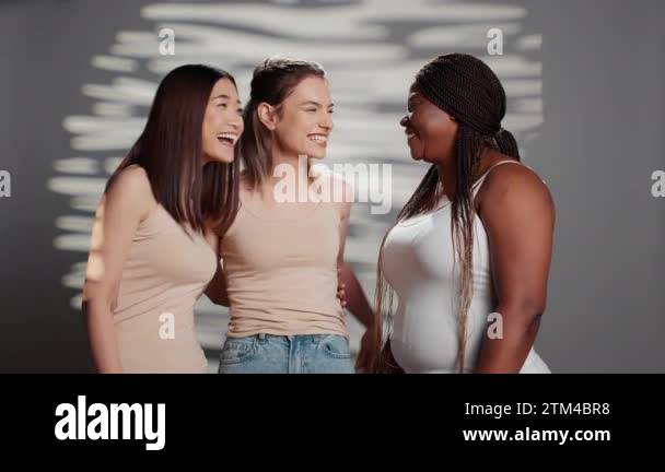 Group of diverse girls feeling positive about body types, laughing and ...