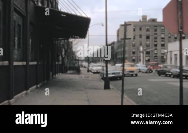 Cars parked in a queue along a filthy sidewalk depict poverty in the ...
