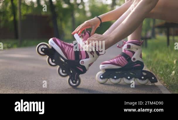 Close-up on the profile of the legs of a girl wearing rollerblades. A ...