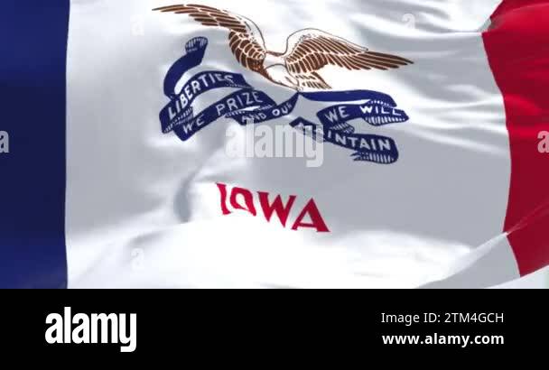 Close-up of the Iowa state flag waving. Three vertical stripes of blue ...