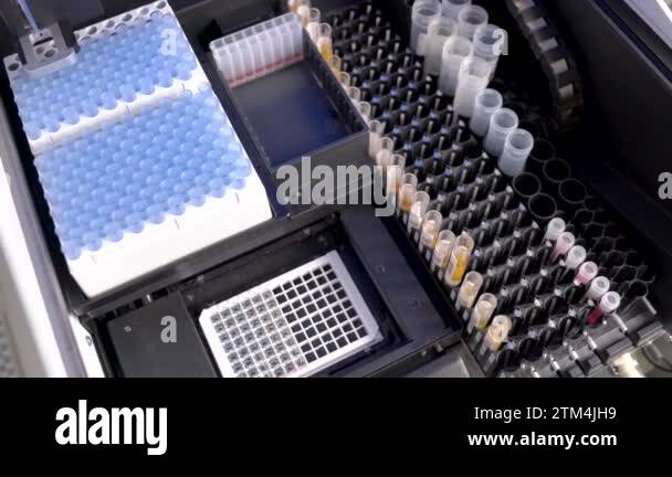 An automatic analyzer taking a dose of blood from tube with biological ...