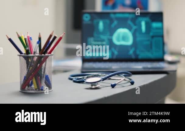 Laptop with human brain scan on desk, neurology x ray running on ...