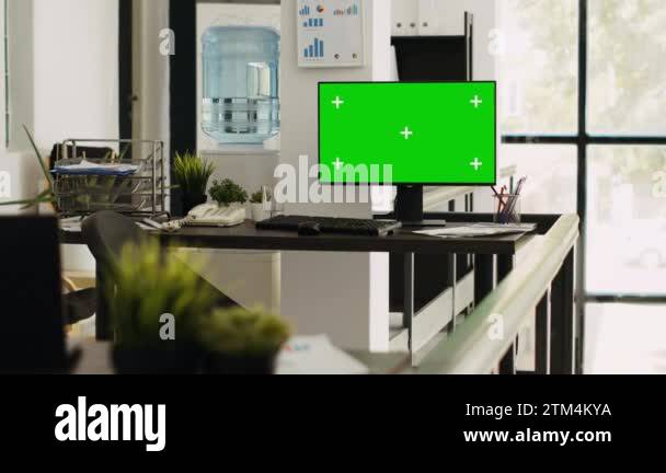 Empty coworking space with pc running isolated greenscreen, blank chromakey display on monitor ...