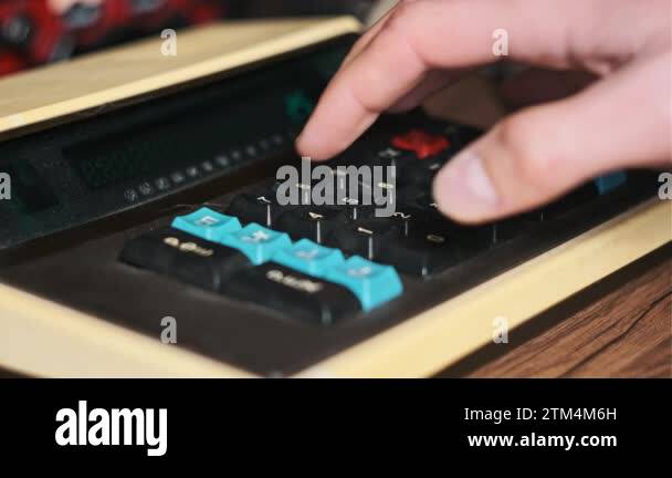 Counting on a vintage calculator. Male hand press buttons on an old ...