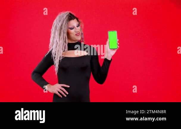 Chroma screen of the mobile held by a transgender person dressed as ...
