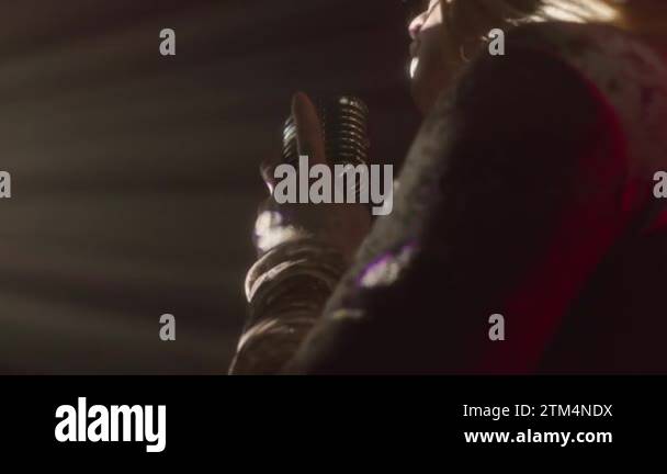 Low angle chest up of artistic Caucasian drag queen singing in ...