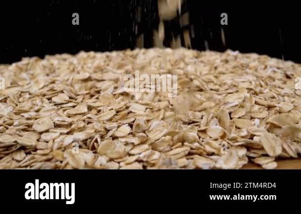 Dry Oat Flakes Falling in Pile Raw Oatmeal on Black Rotating Background ...