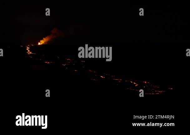 Red orange yellow glowing hot lava and magma erupting out of volcano at ...