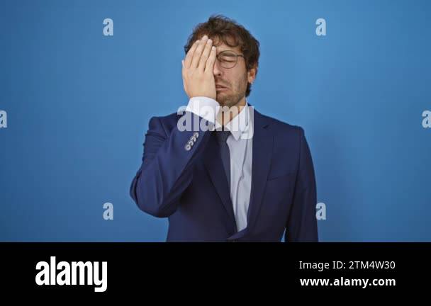 Young man in business suit tired from late work night, yawning and ...