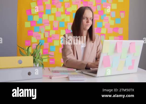 Despair tired woman freelancer wearing beige jacket sitting in office ...