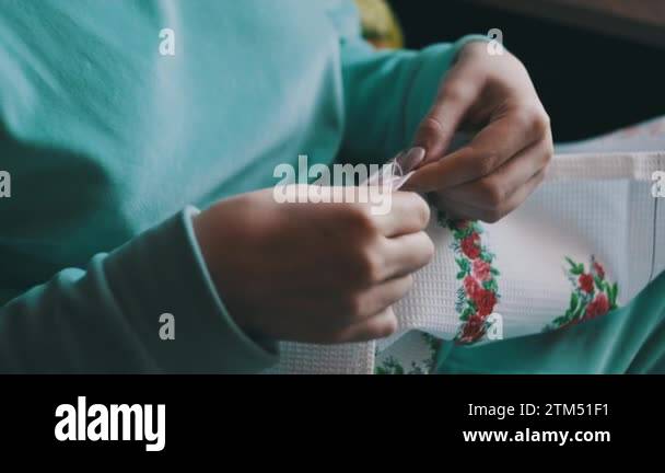 Beautiful female hands sew manually with thread and needle. Young woman ...