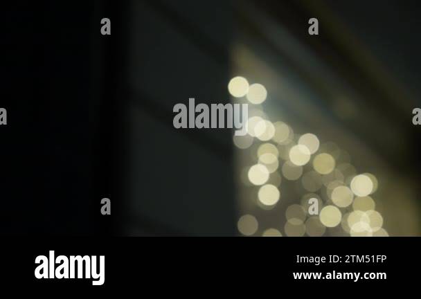 Pan shot moving from left to right showing bokeh christmas lights ...