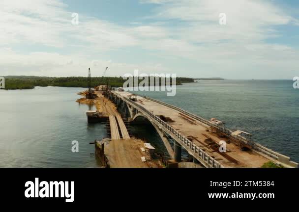 Bridge under construction over the sea bay connecting the two parts of ...