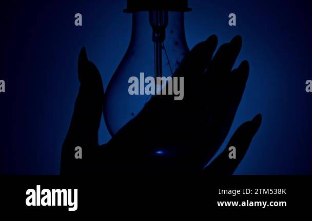 Light bulb turns on and goes out at the touch of a persons hand in the ...