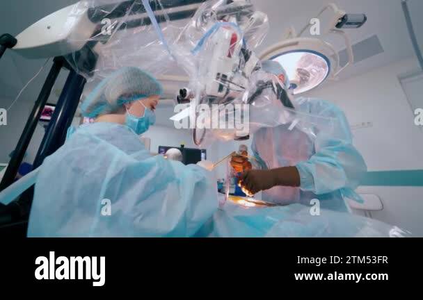 Surgical procedure. Professional doctor performing an operation while ...
