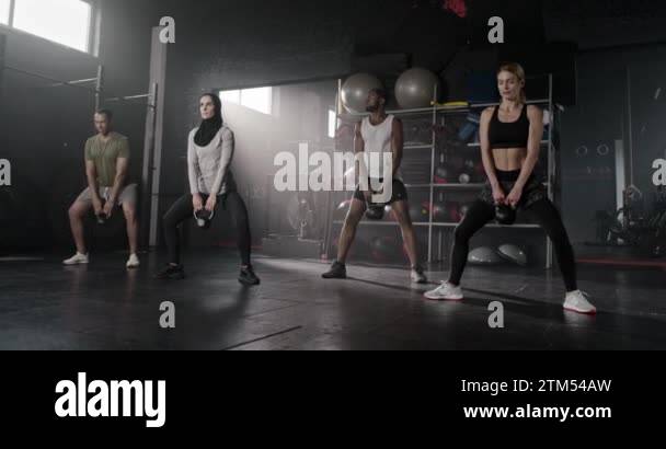 Mixed-raced group in sportswear training muscles and practicing ...