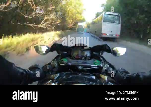 Point of view of a motorcycle rider rides in country road with traffic ...