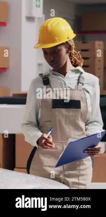 Vertical video: Multiethnic group of workers reviewing goods in depot ...