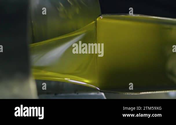 Olive oil machine working at factory closeup. Golden extra virgin ...