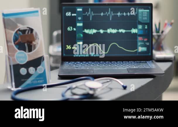 Heart rate monitor on laptop at counter, showing electrocardiogram for ...
