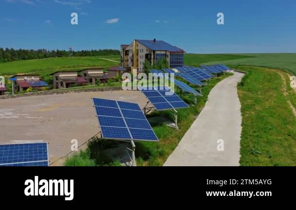 Building with solar panels in nature. Blue sunny batteries along the ...