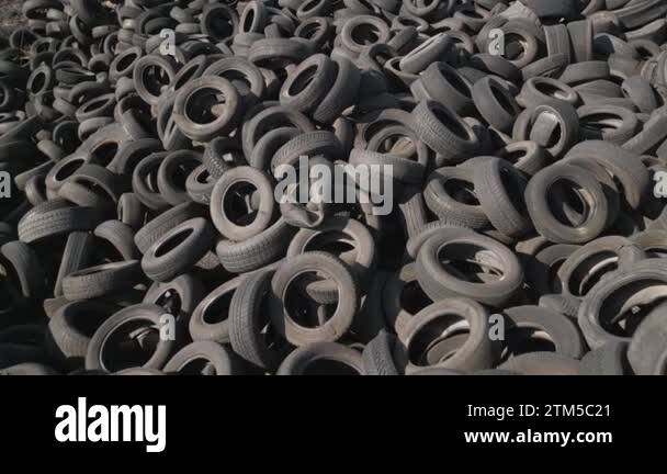 This striking top-down view captures a massive dump of car tires ...