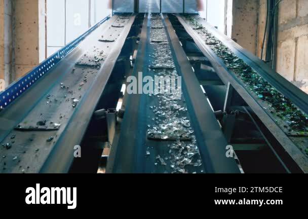 Process of sorting glass garbage on a conveyor belt at waste sorting ...