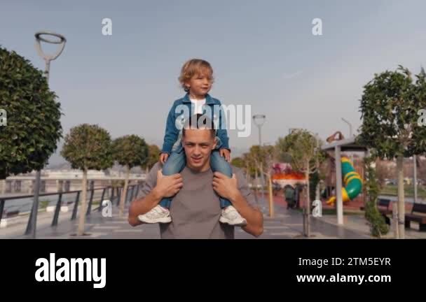 The son sits on the shoulders of his father, plays a pilot, flies as a ...