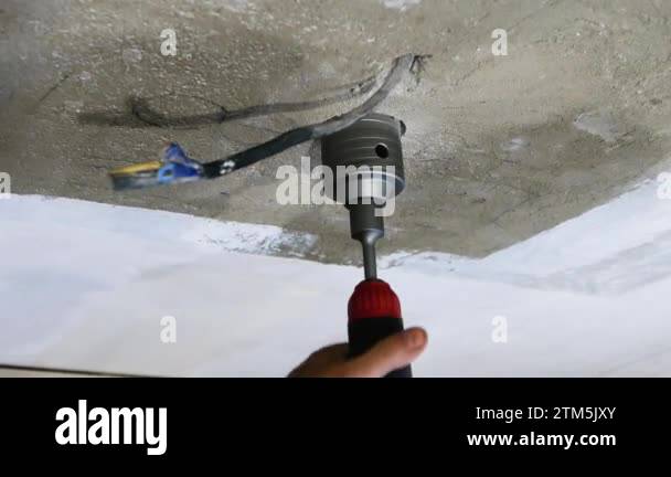 Top view, Installation of socket boxes in the wall. A male worker is ...